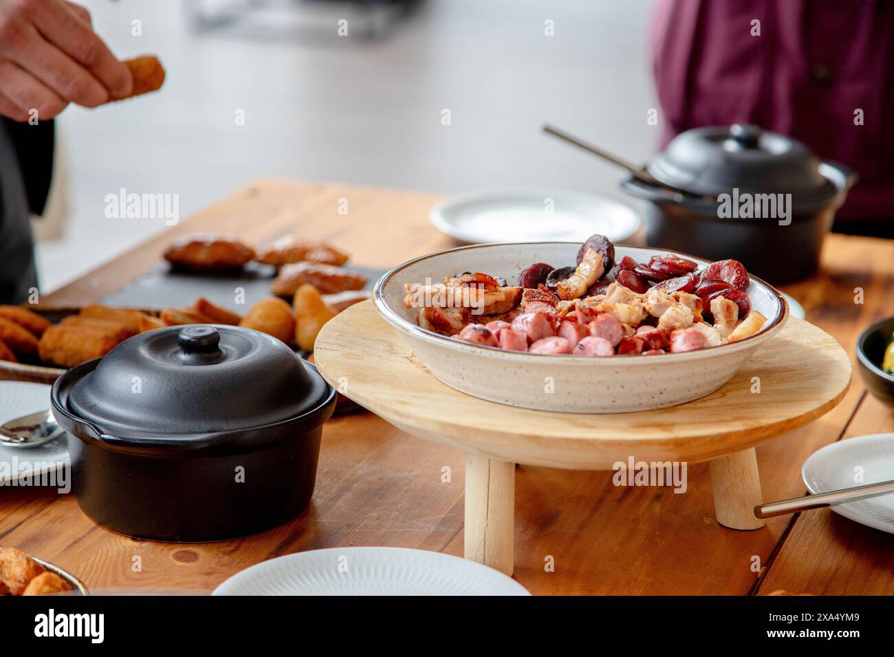 People enjoying a buffet-style meal, serving themselves from a variety ...