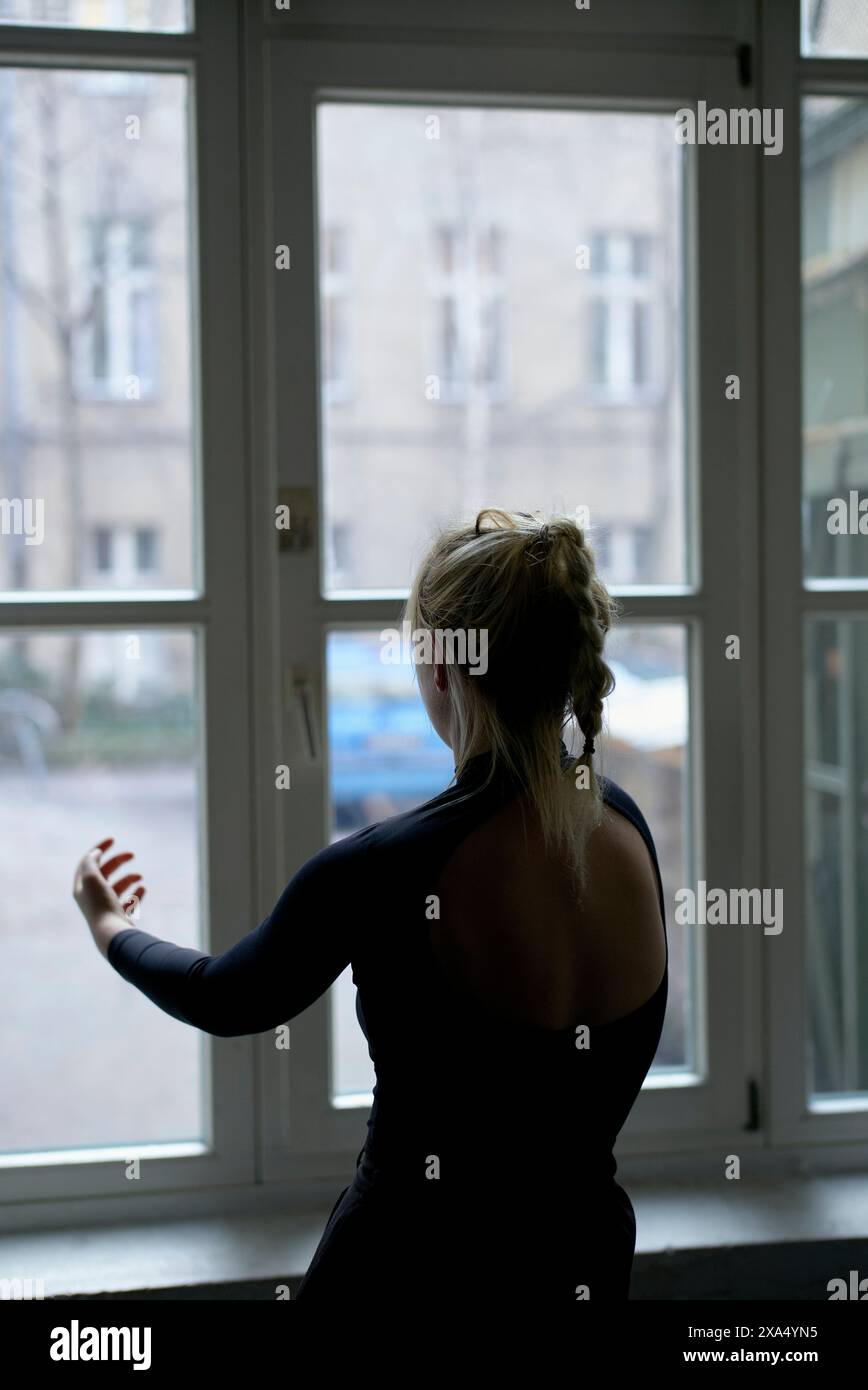Back view woman ponytail standing by window hi-res stock photography ...