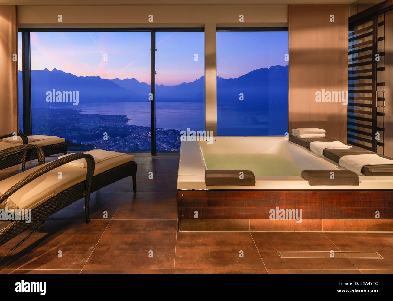 Sunset view from a luxurious indoor spa area with large windows ...