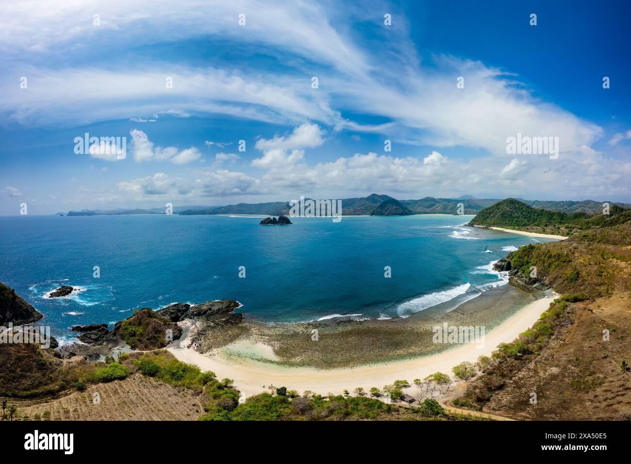Aerial view of a beautiful, deserted tropical beach surrounded by deep ...