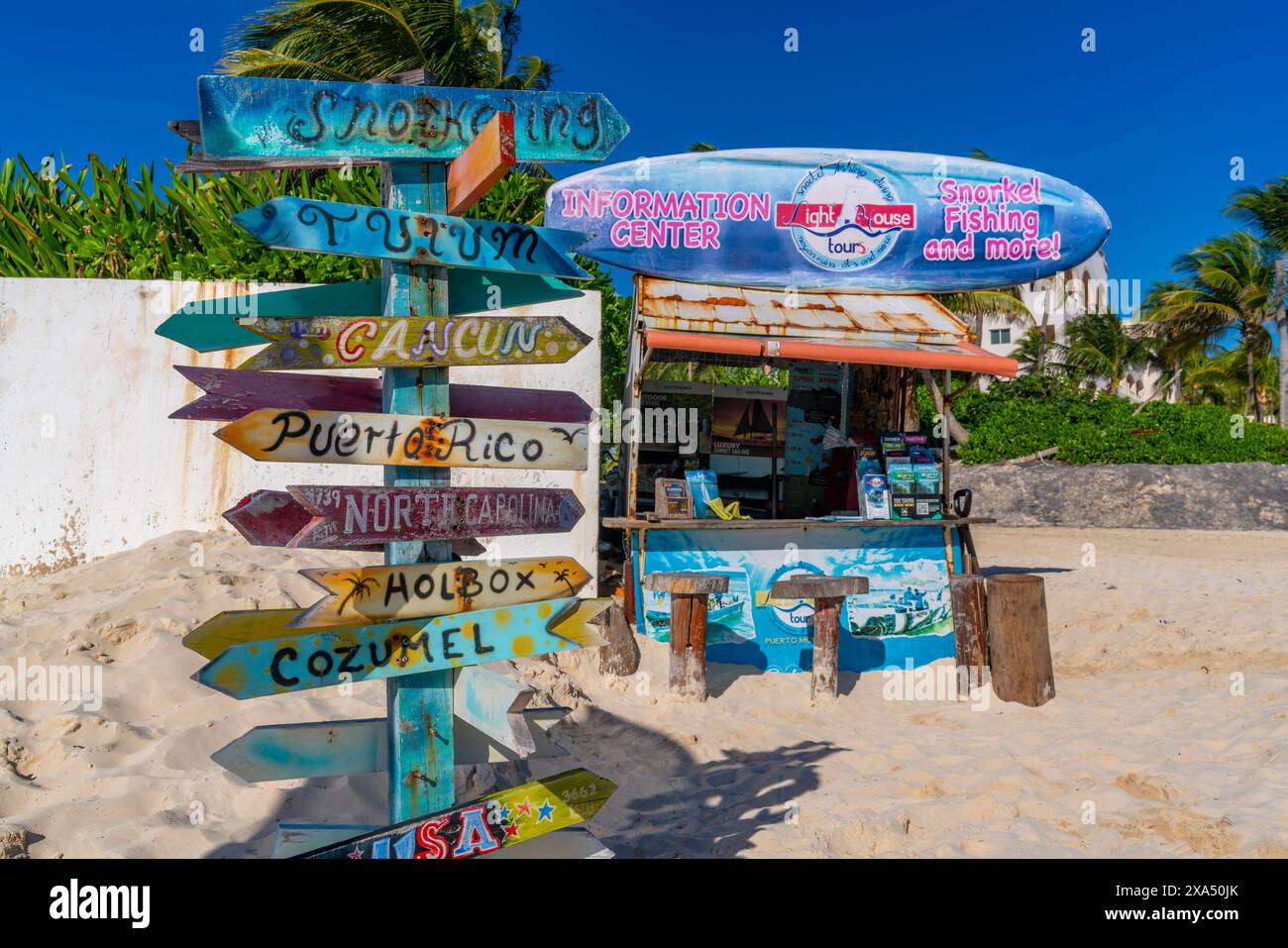 View of colourful destination sign on beach at Puerto Morelos ...