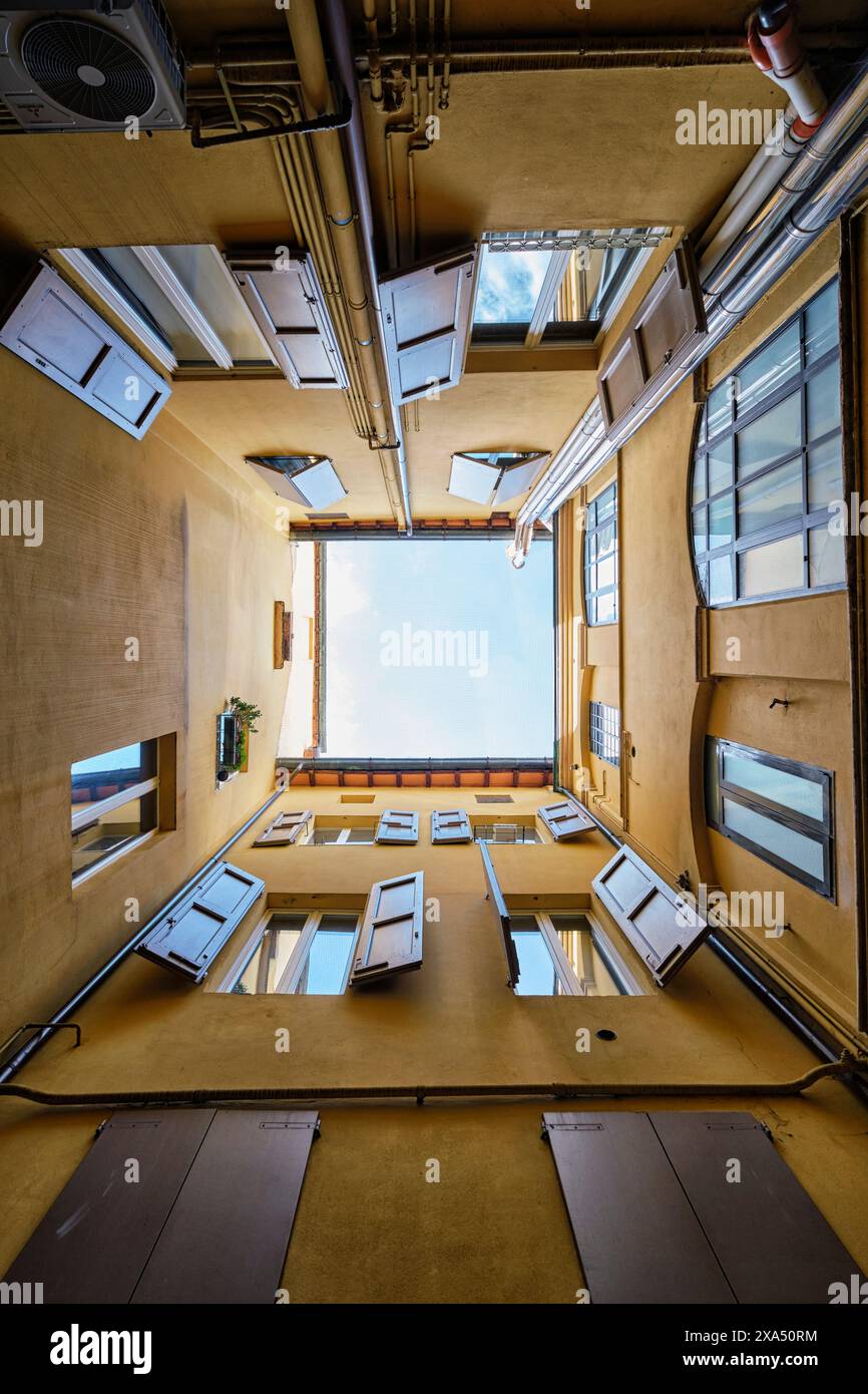 An upward view of the sky from a courtyard in Modena, Italy Stock Photo ...