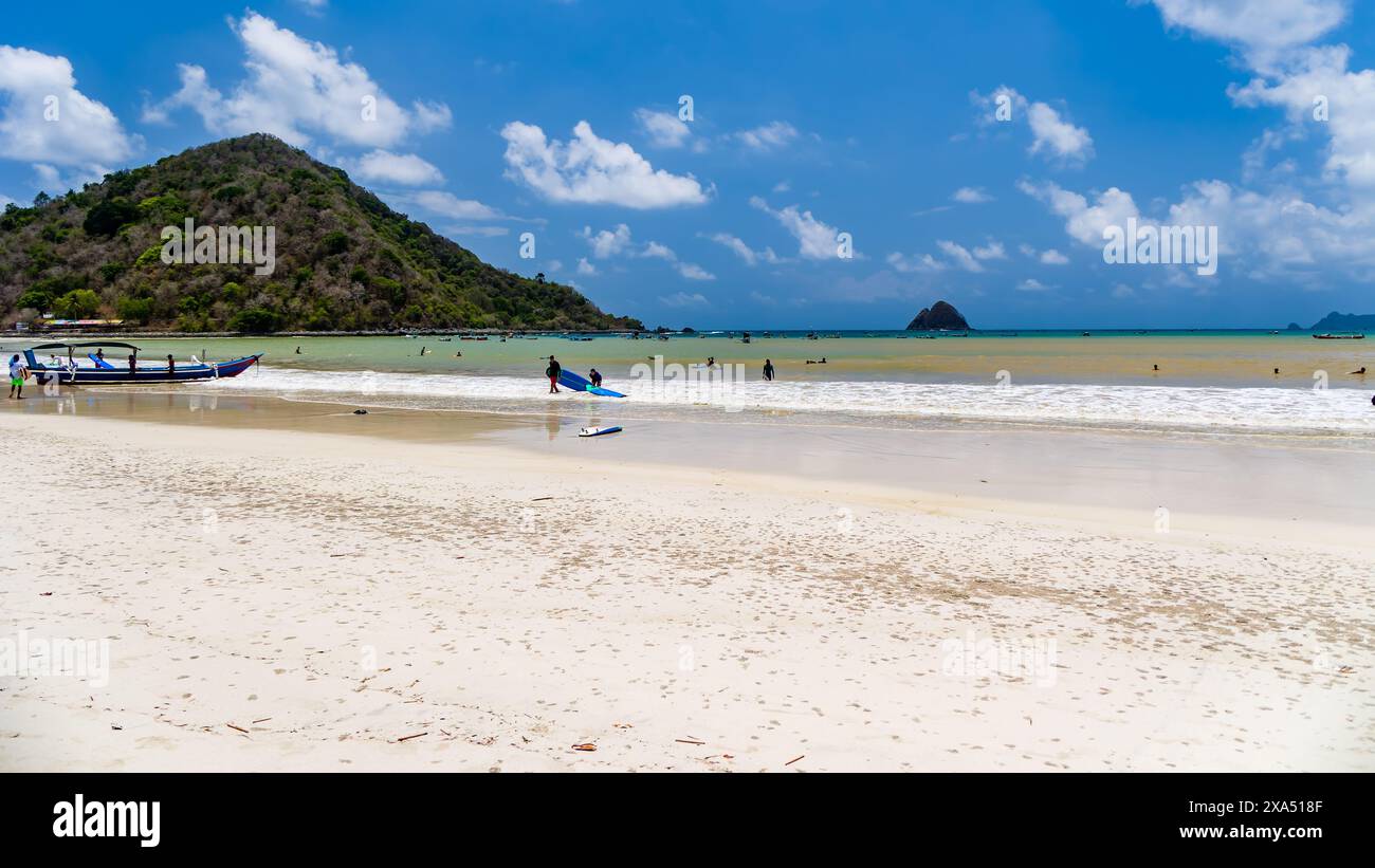 Surfers on the beach of Selong Belanak on the island of Lombok ...