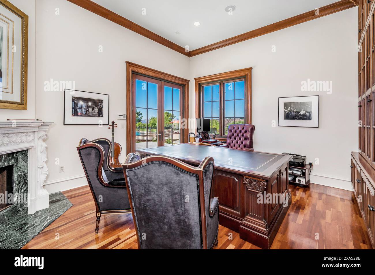 A spacious wooden desk with numerous drawers and a clock on top Stock ...