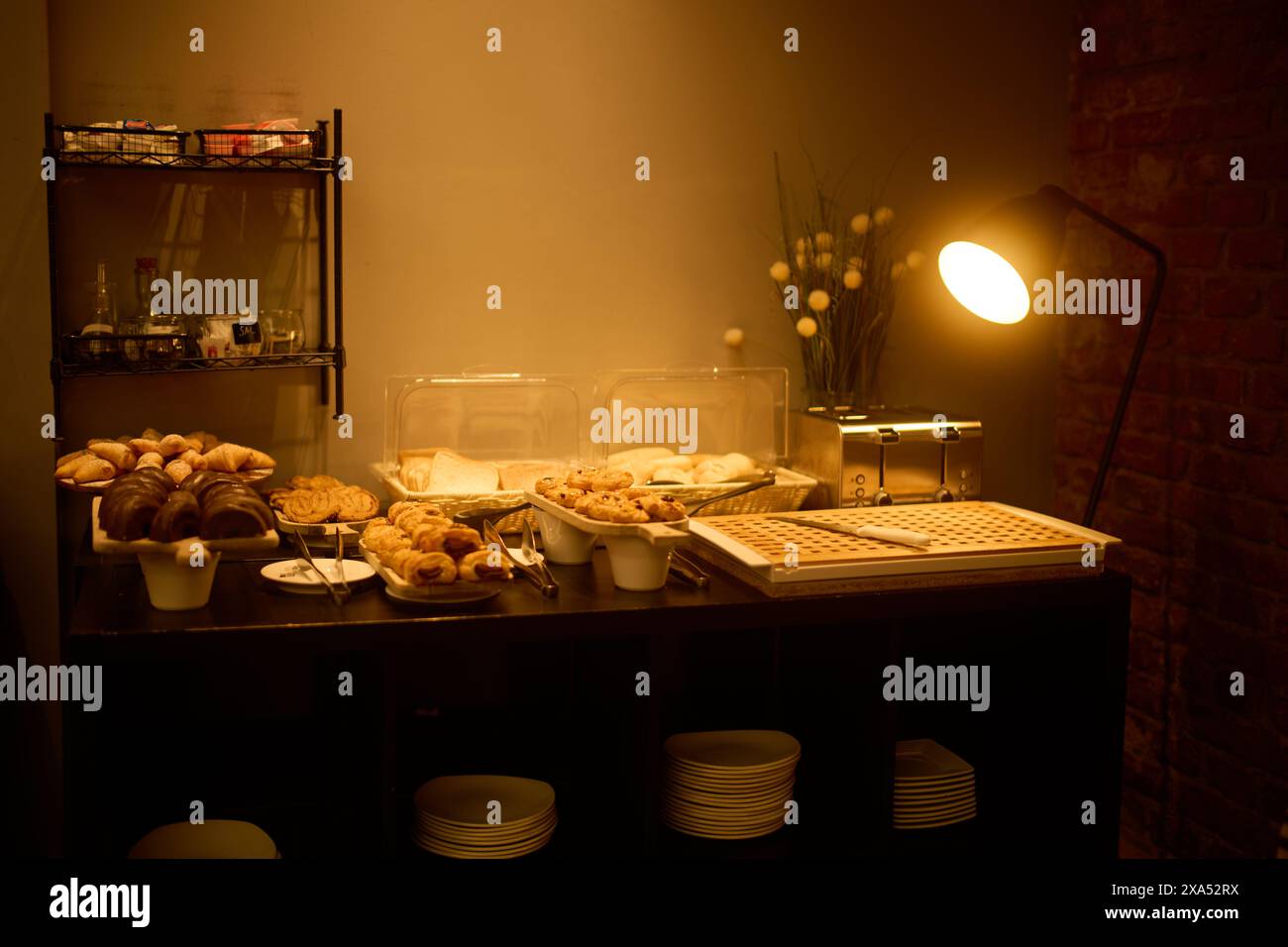 A table set with plates, bowls of food, and a lamp in Madrid, Spain ...