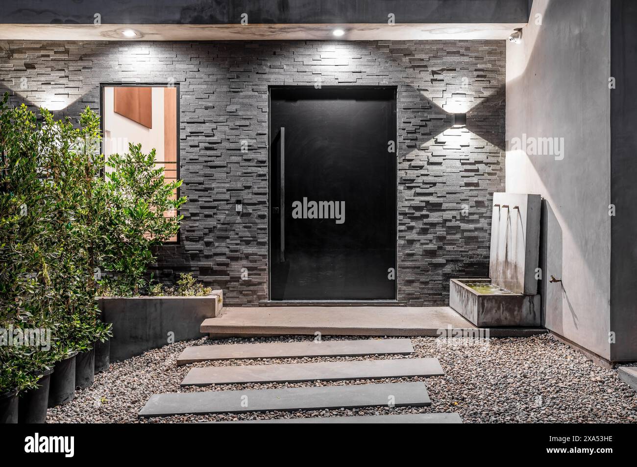 Nighttime entrance lighting with surrounding foliage Stock Photo - Alamy