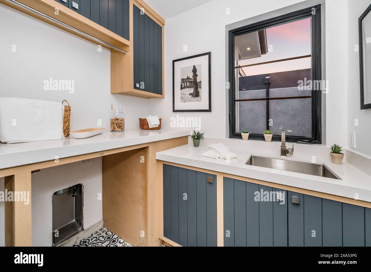 A modern kitchen featuring a sink, microwave, and window Stock Photo ...