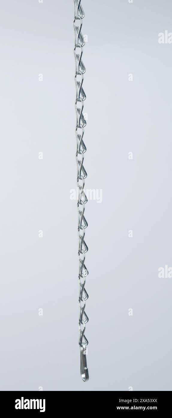 Long linked metal shiny chain with hook isolated on white studio ...