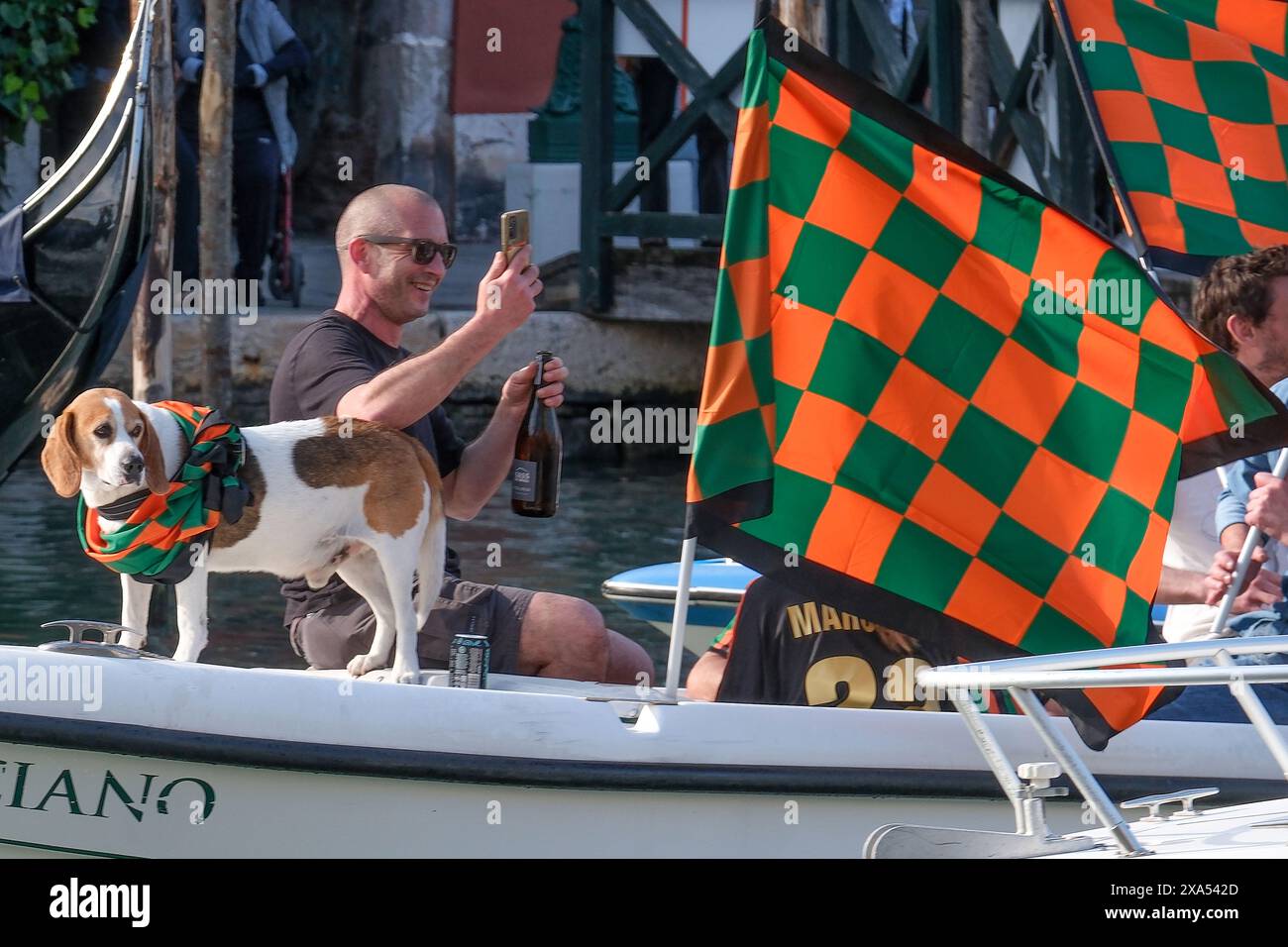Venezia players celebrate promotion to Serie A with fans on the Grand ...