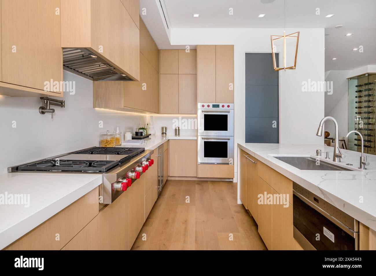 Spacious kitchen with sleek countertops and modern stove Stock Photo ...