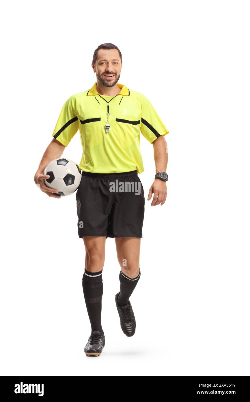 Portrait of a football referee carrying a ball and walking towards ...