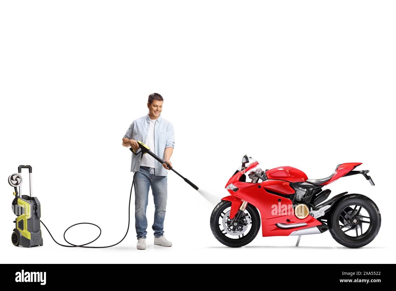 Man washing a racing motorbike with a high pressure washer machine ...
