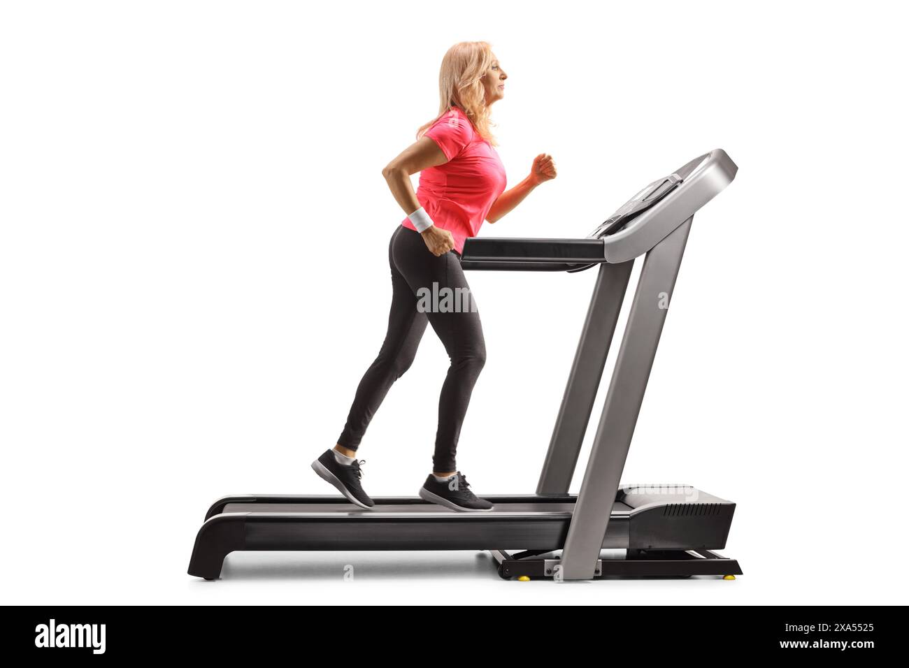 Full length profile shot of a middle aged woman running on a treadmill ...