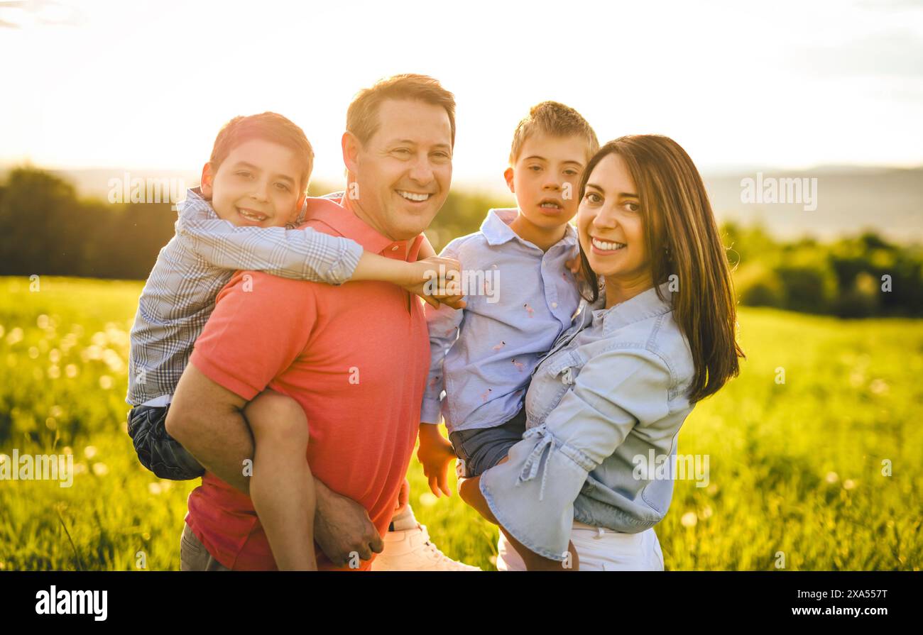 Nice family Playing on great field at Sunset Stock Photo - Alamy