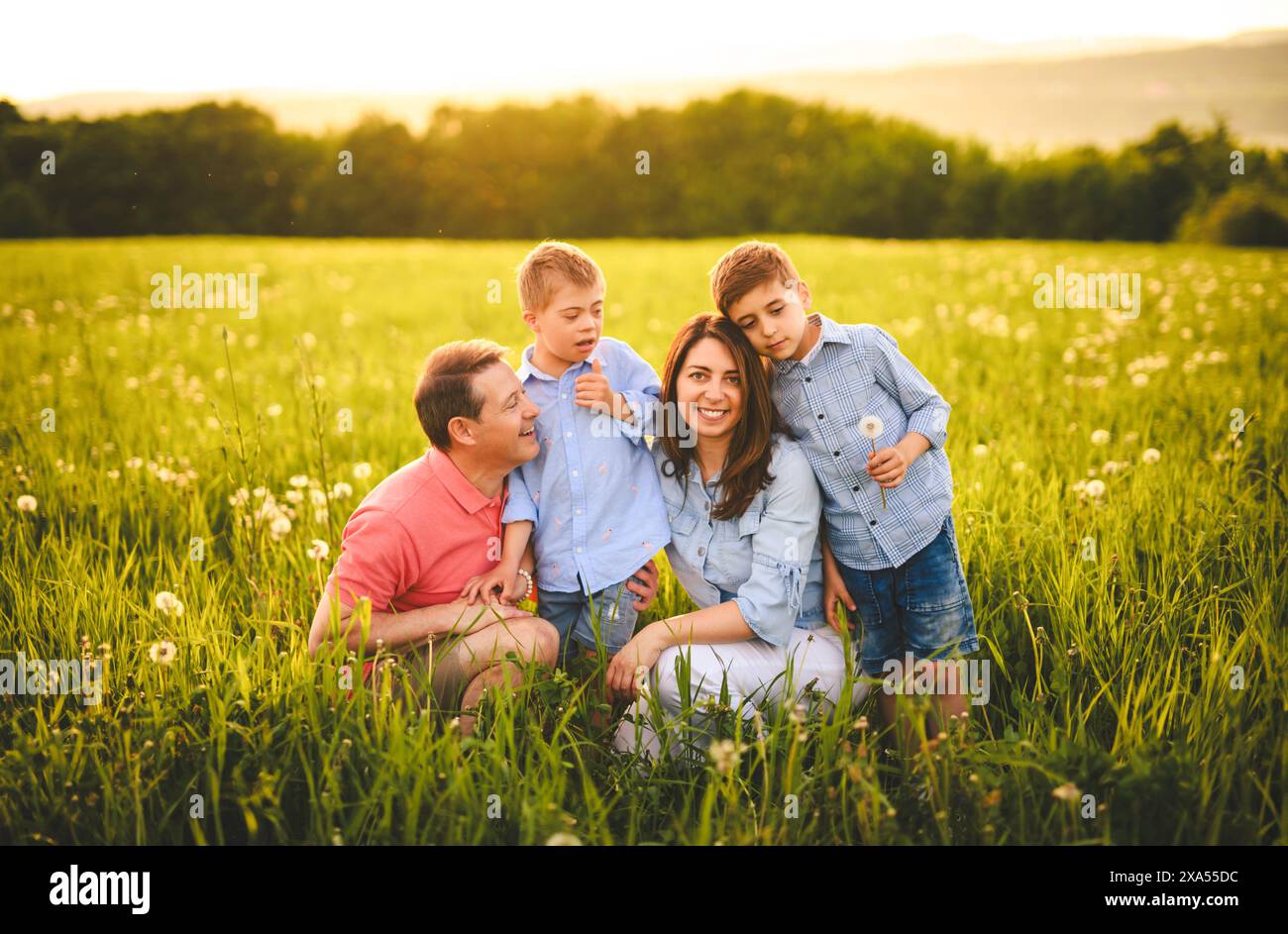 Nice family Playing on great field at Sunset Stock Photo - Alamy