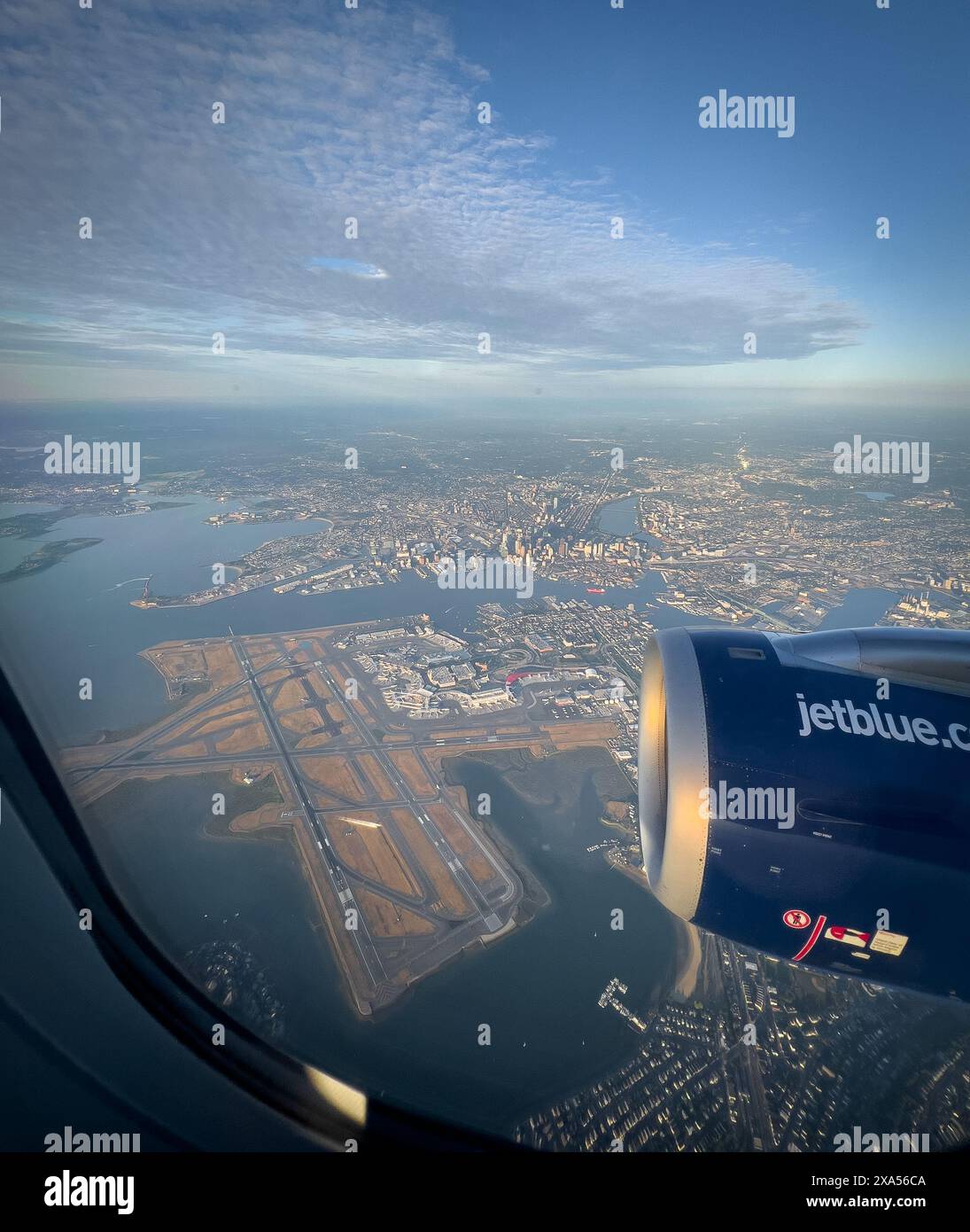 A window view from a Jetblue airways plane as it flys over Boston's ...