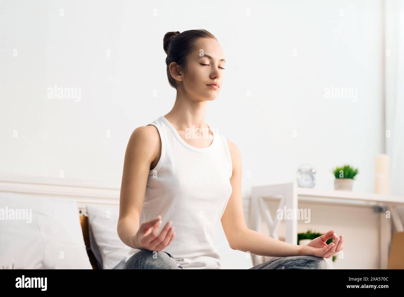 Fit girl doing lotus pose hi-res stock photography and images - Alamy