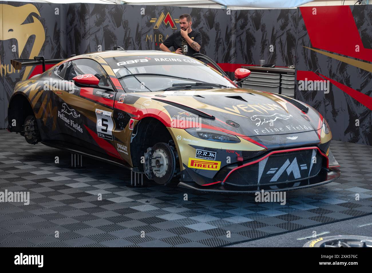 Pit tent of a GT4 European Series racing team. The driver is observing ...