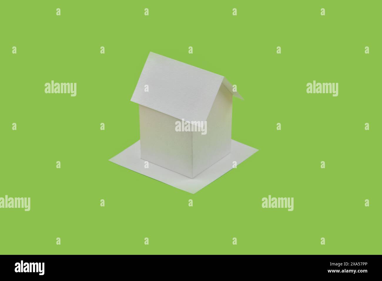 Homemade cardboard house model, white small house on a green background ...
