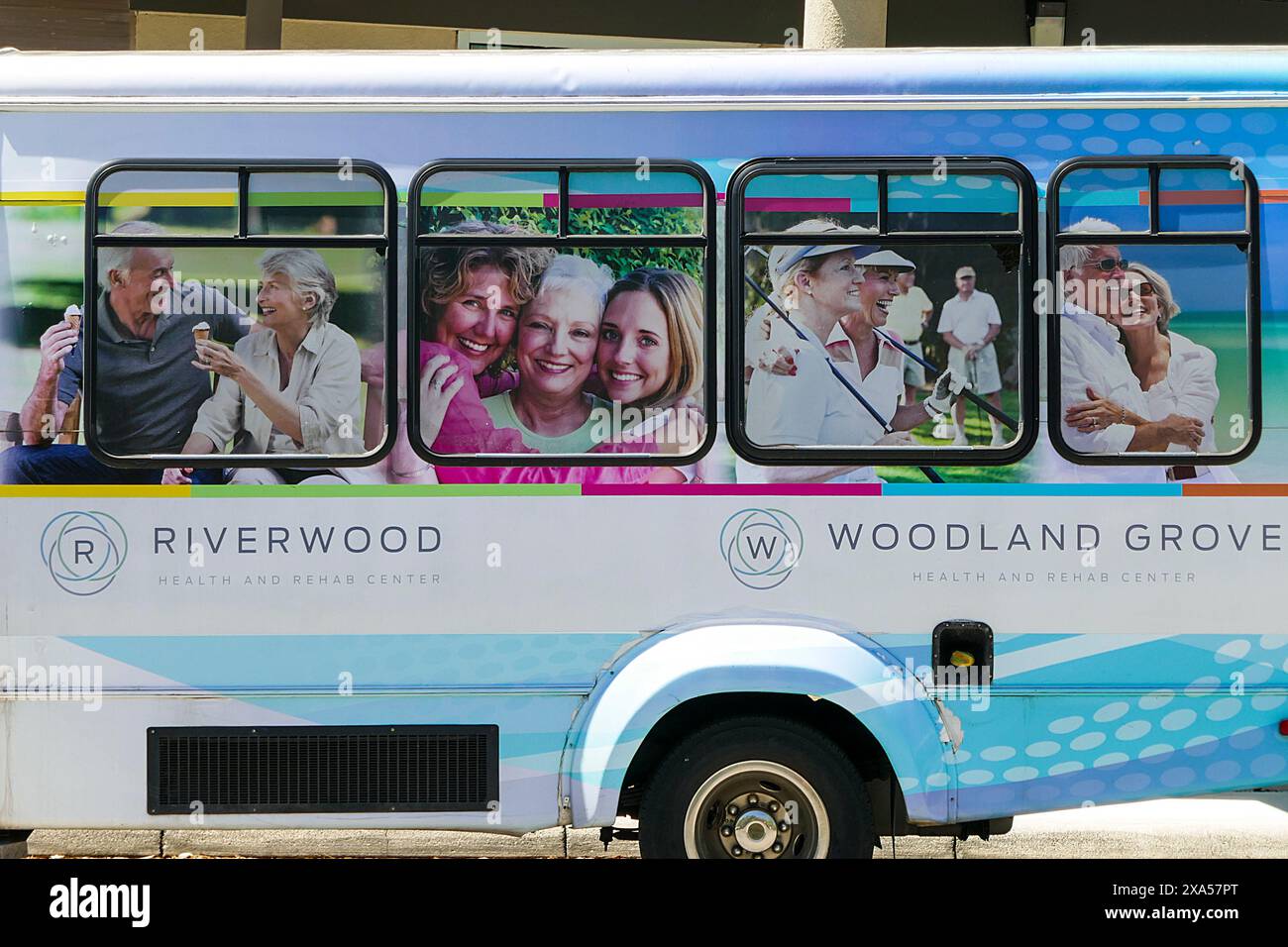 A senior center transportation bus waits by a shopping mall for its ...