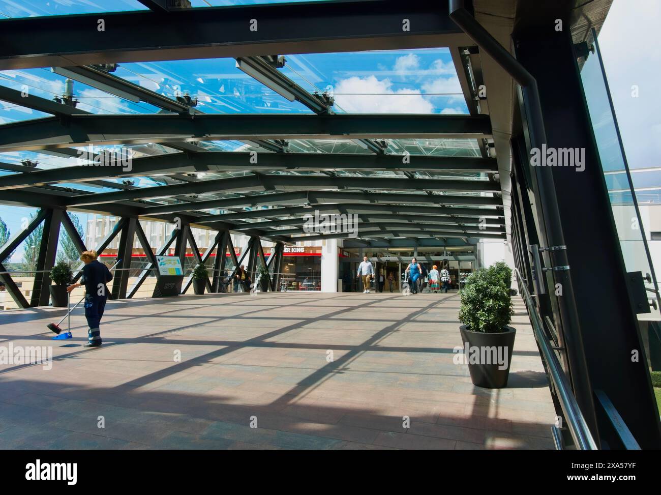 Footbridge with a glass roof to the entrance of the Fashion Outlet ...