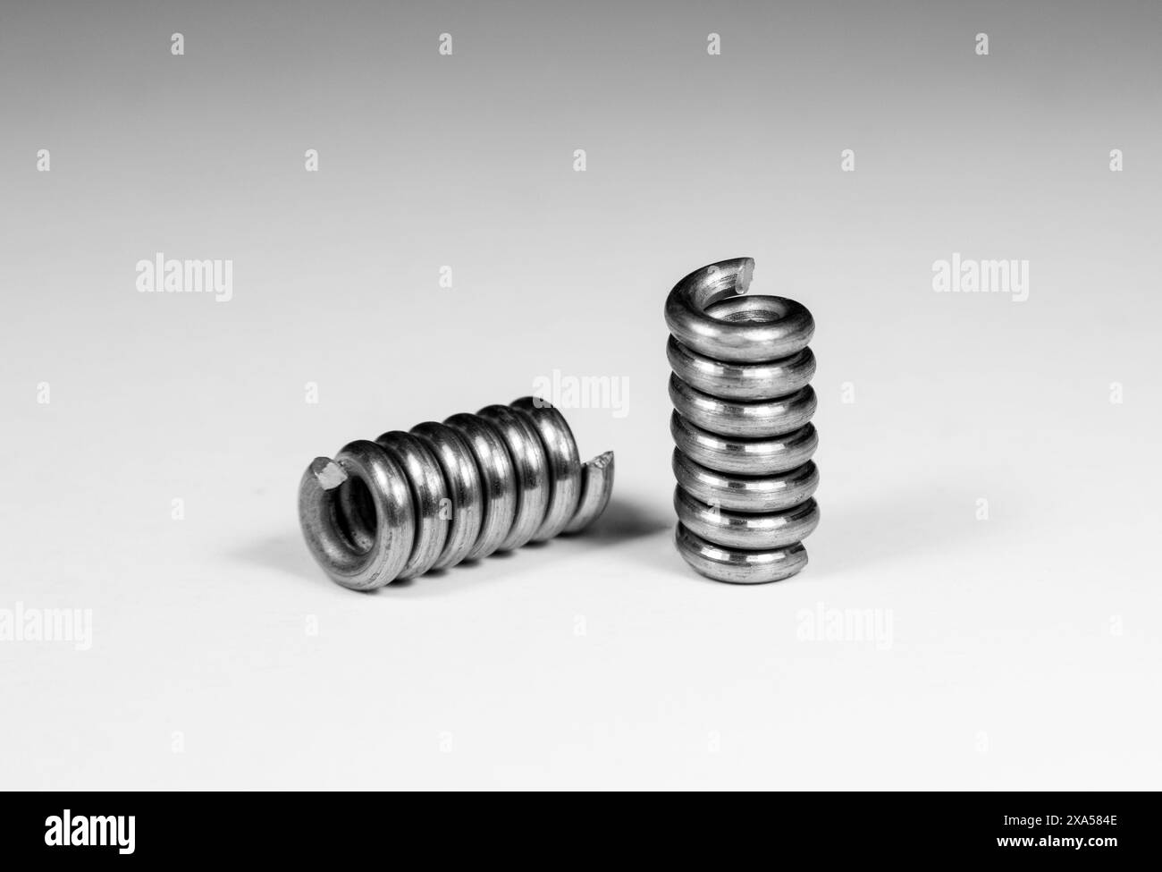 A close-up of metal spiral springs on a white background Stock Photo ...