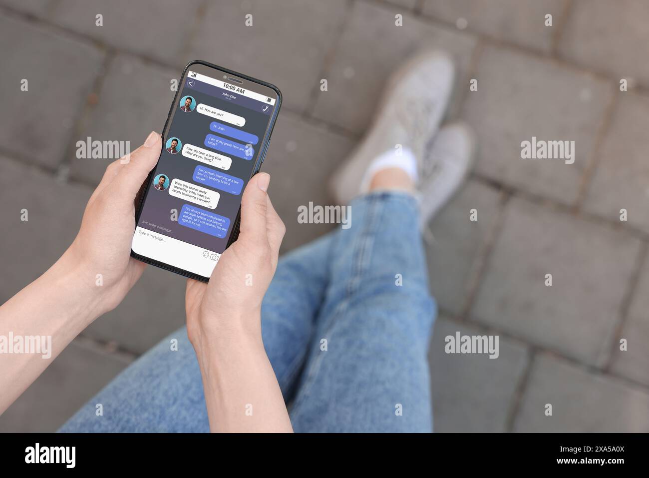 Woman texting via mobile phone outdoors, closeup. Device screen with ...