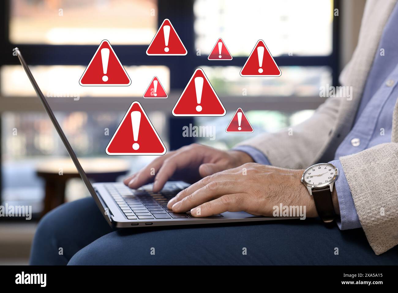 Man using laptop at table, closeup. Warning signs for spam messages ...