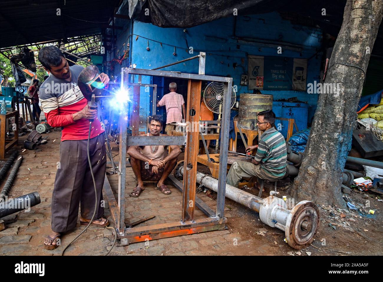 A labour seen working at a roadside workshop ahead of the final ...