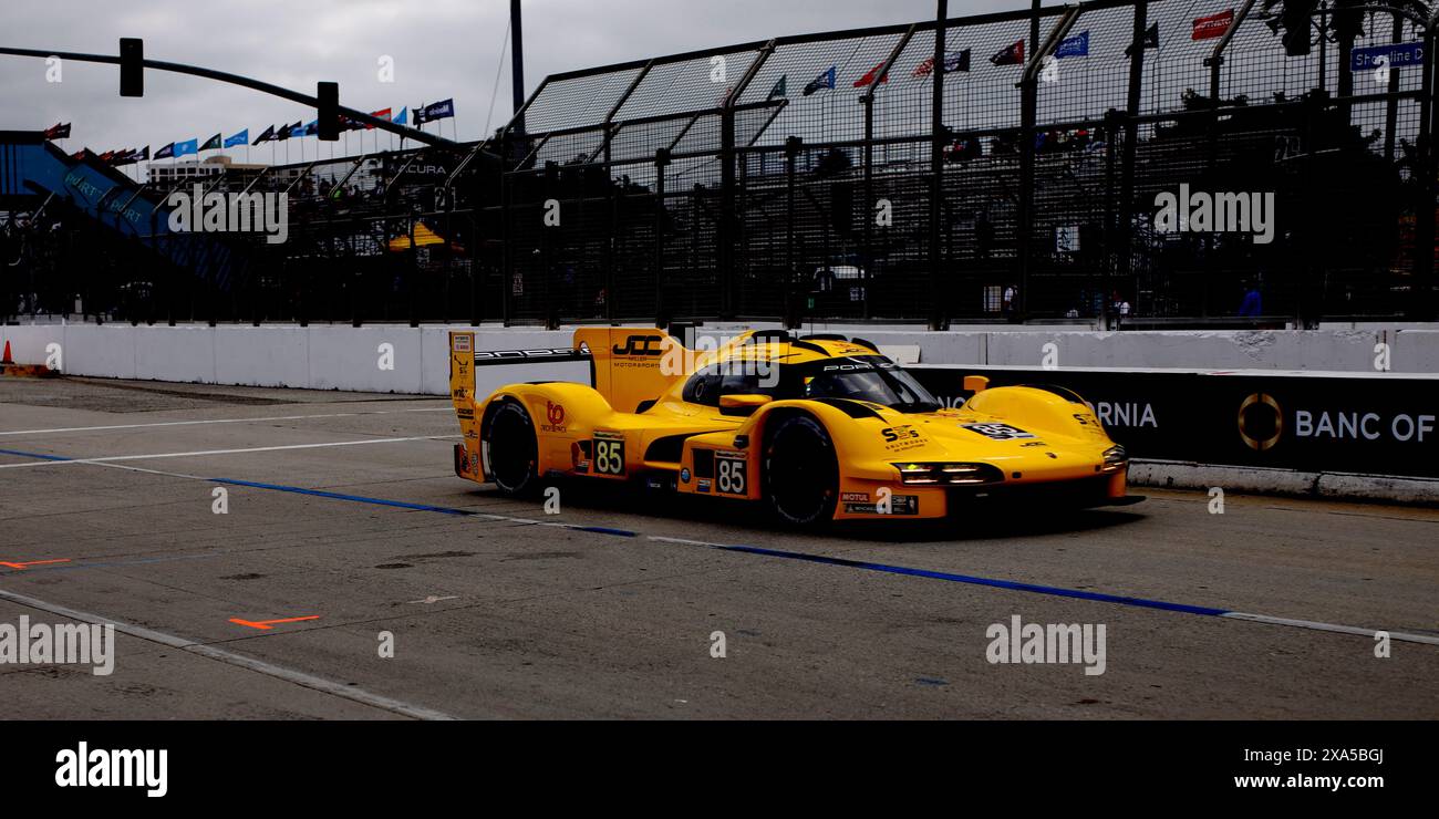 A porsche racing car yellow number 85 imsa challange Stock Photo - Alamy