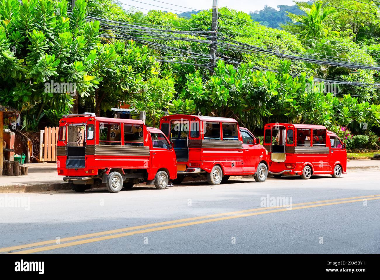Three thai traditional red tuk tuk taxi (songthaew) in Krabi, Thailand ...