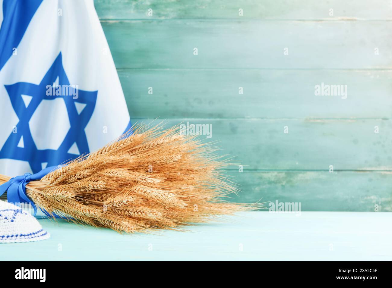 Shavuot jewish background. Ripe bouquet of wheat with blue ribbon ...