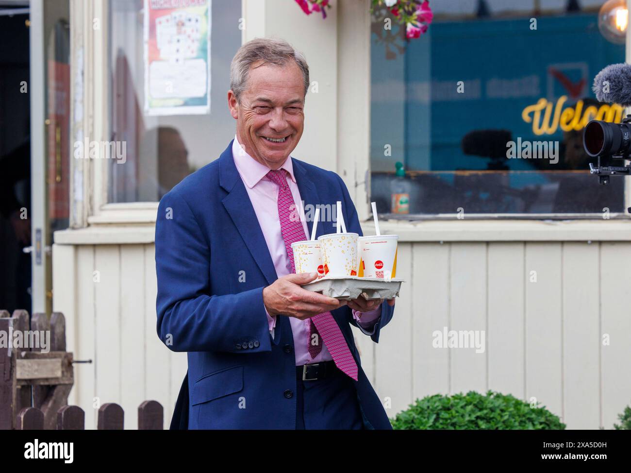 London, UK. 4th June, 2024. Nigel Farage carriers a tray with 4 ...