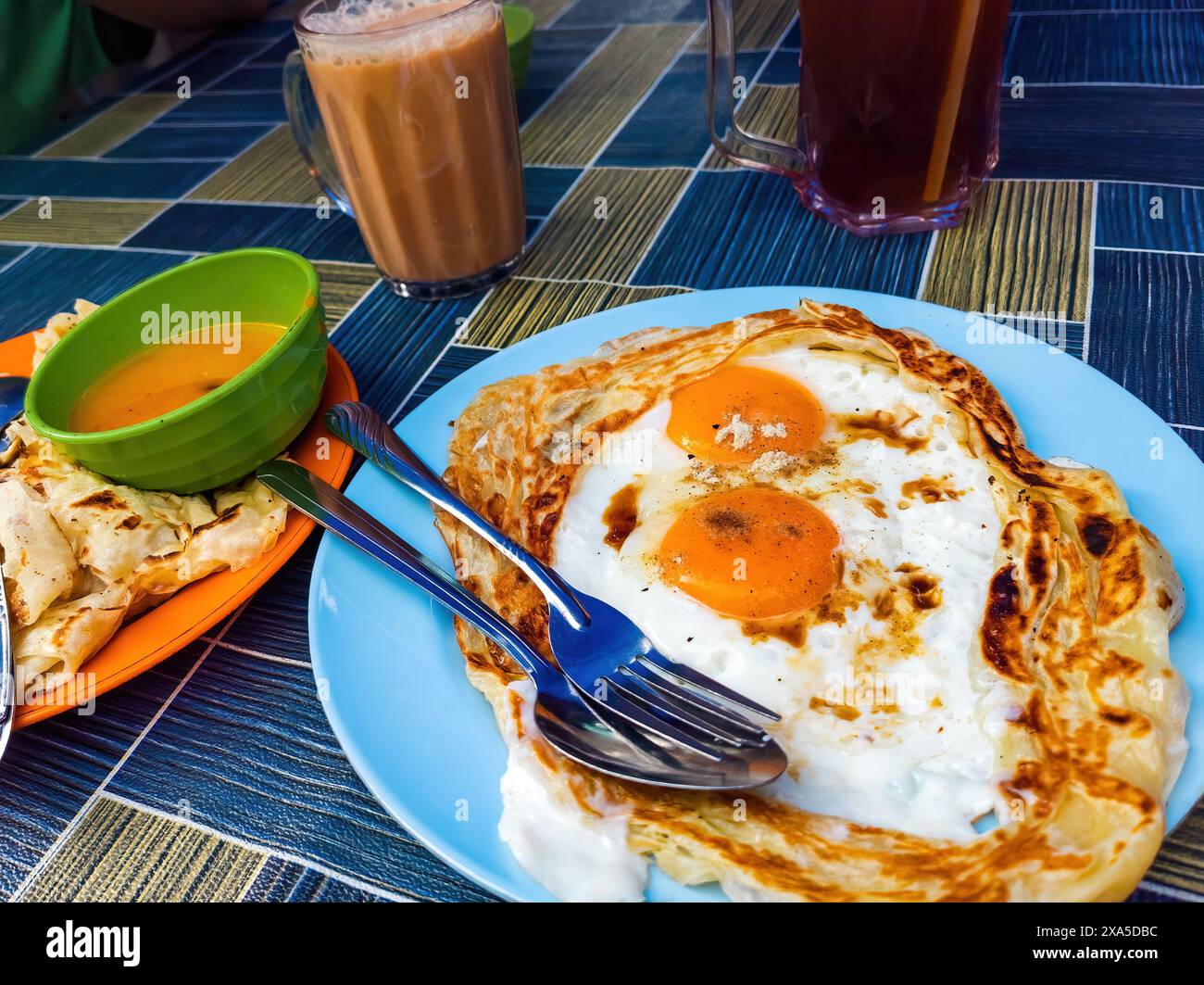 Roti sarang burung, a pratha looks like bird nest with half cook eggs ...