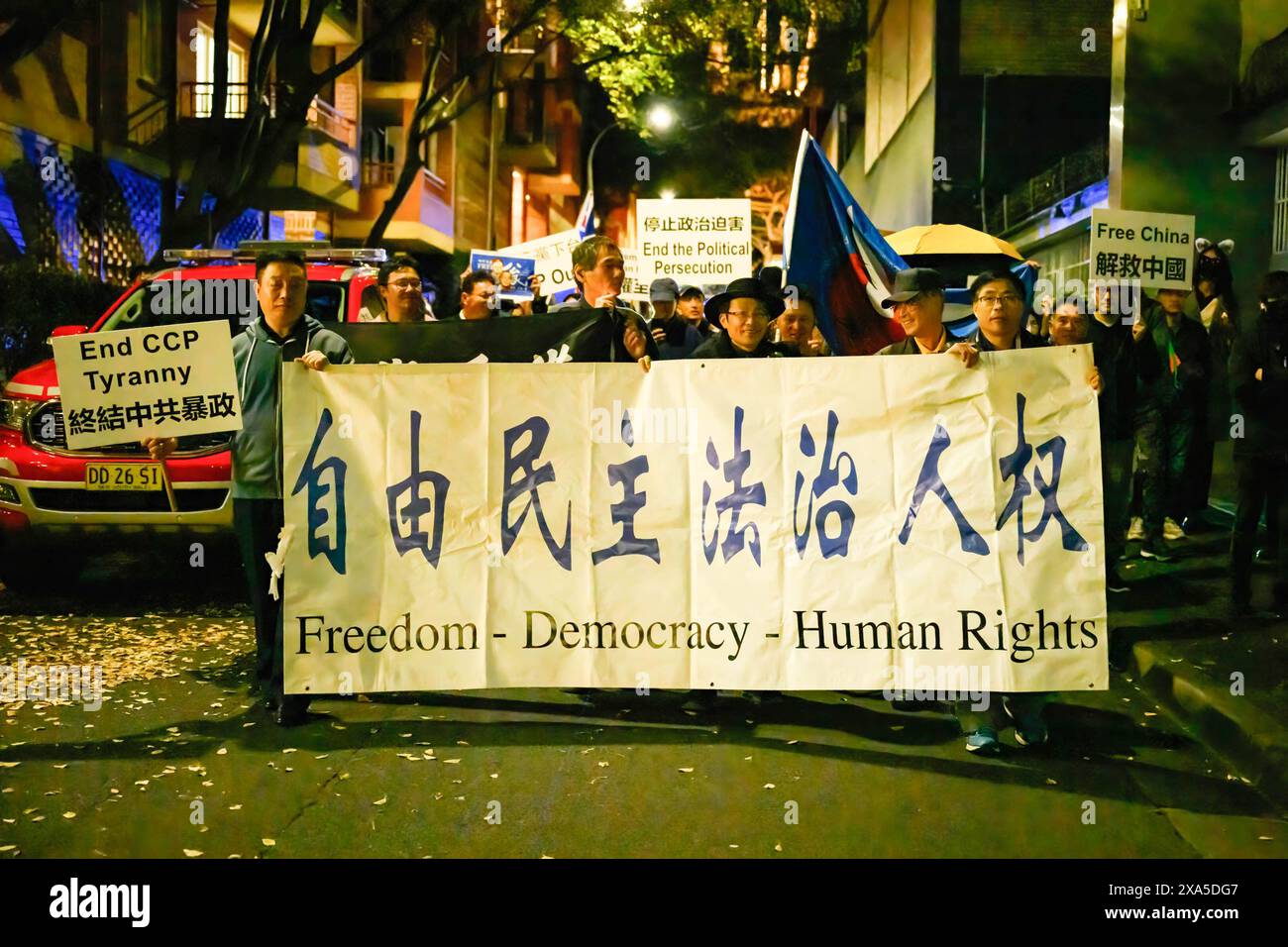 Protesters seen marching on the street while holding a "Freedom ...