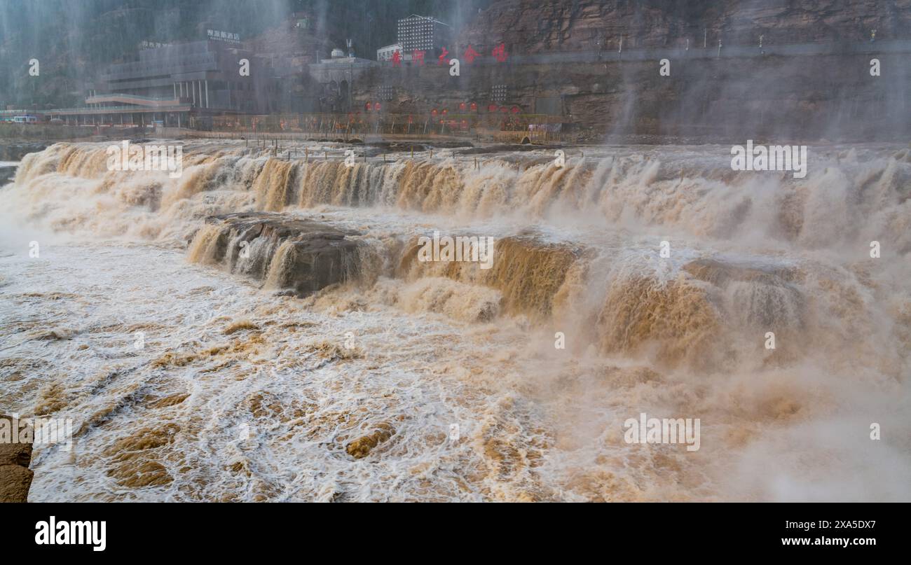Rainfall creates cascading water into river over rocks Stock Photo - Alamy