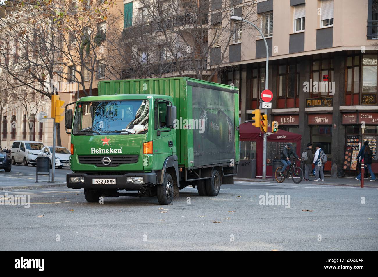 Front view of a green Heineken beer delivery truck stopped on a corner ...