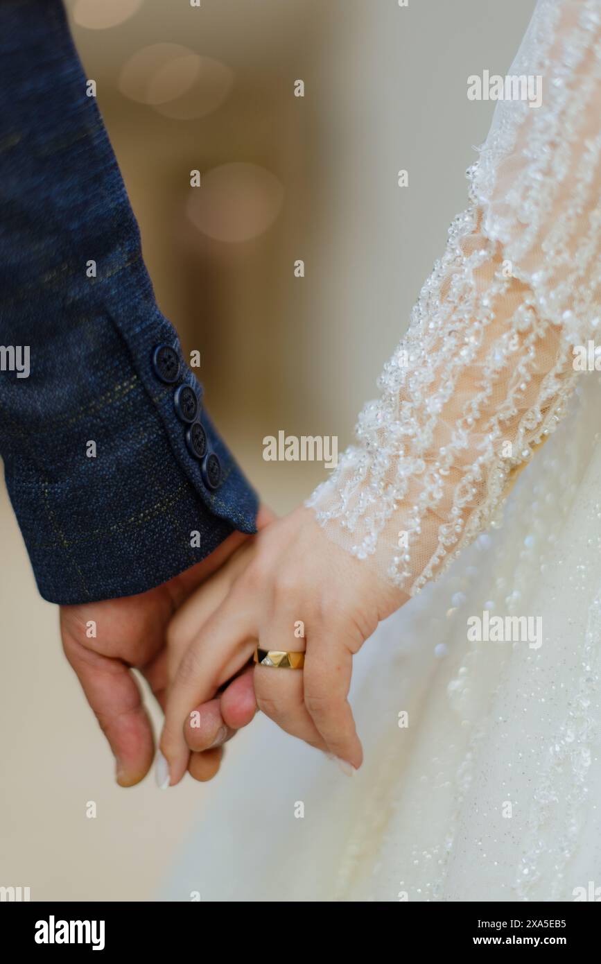 The bride and groom holding hands Stock Photo - Alamy