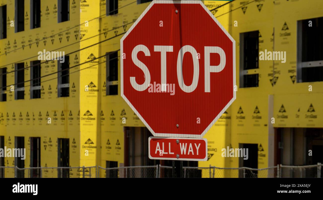 stop sign in front of a building construction site Stock Photo - Alamy