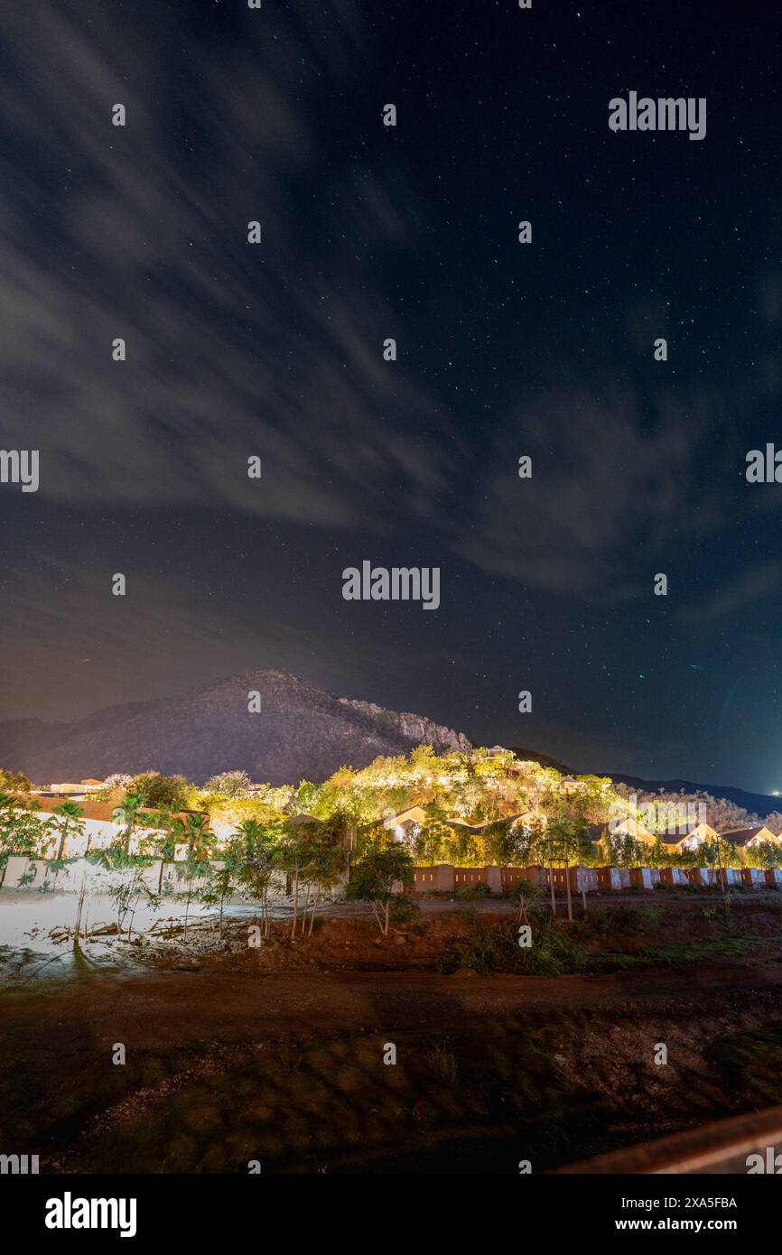 The stars shining brightly above a city at night on a clear evening ...