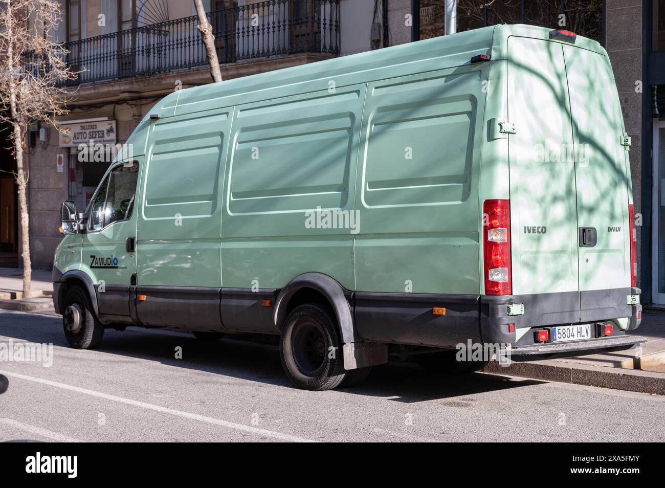 A large green Iveco Daily delivery van parked on the streets of the ...