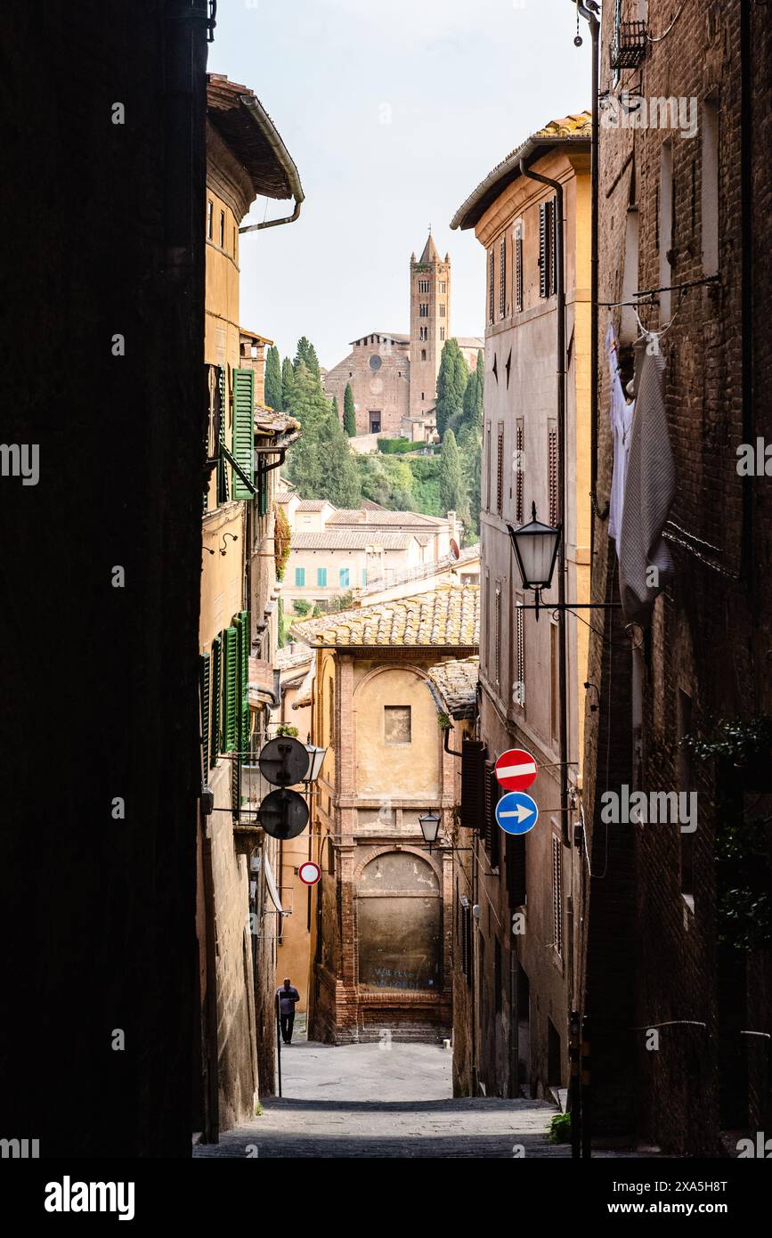 A classic medieval Italian alley with a church in the distance Stock ...