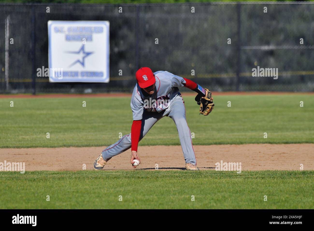 Illinois, USA. Second baseman making a bare-handed pickup of a ...