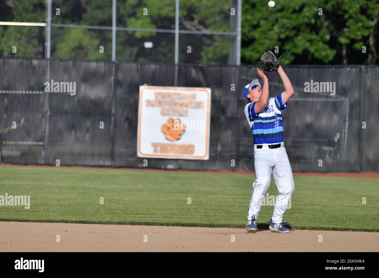 Illinois, USA. First baseman making a catch of a routine pop fly during ...