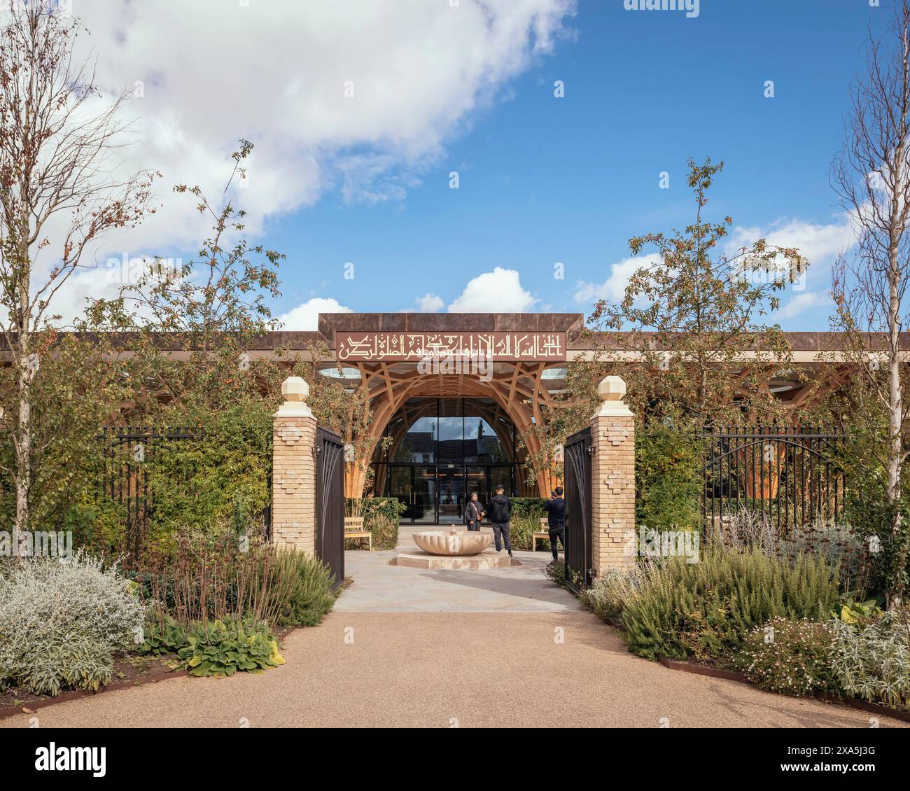 Entrance, fence, gate, arched doorway and exterior planting centrally ...