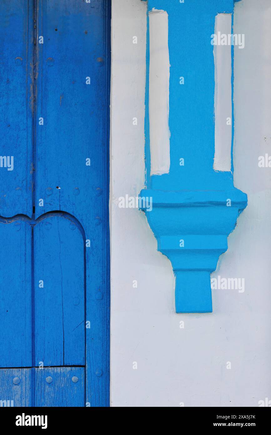 360 Thick, old, azure blue wood door and a pillar-like plaster motif in ...