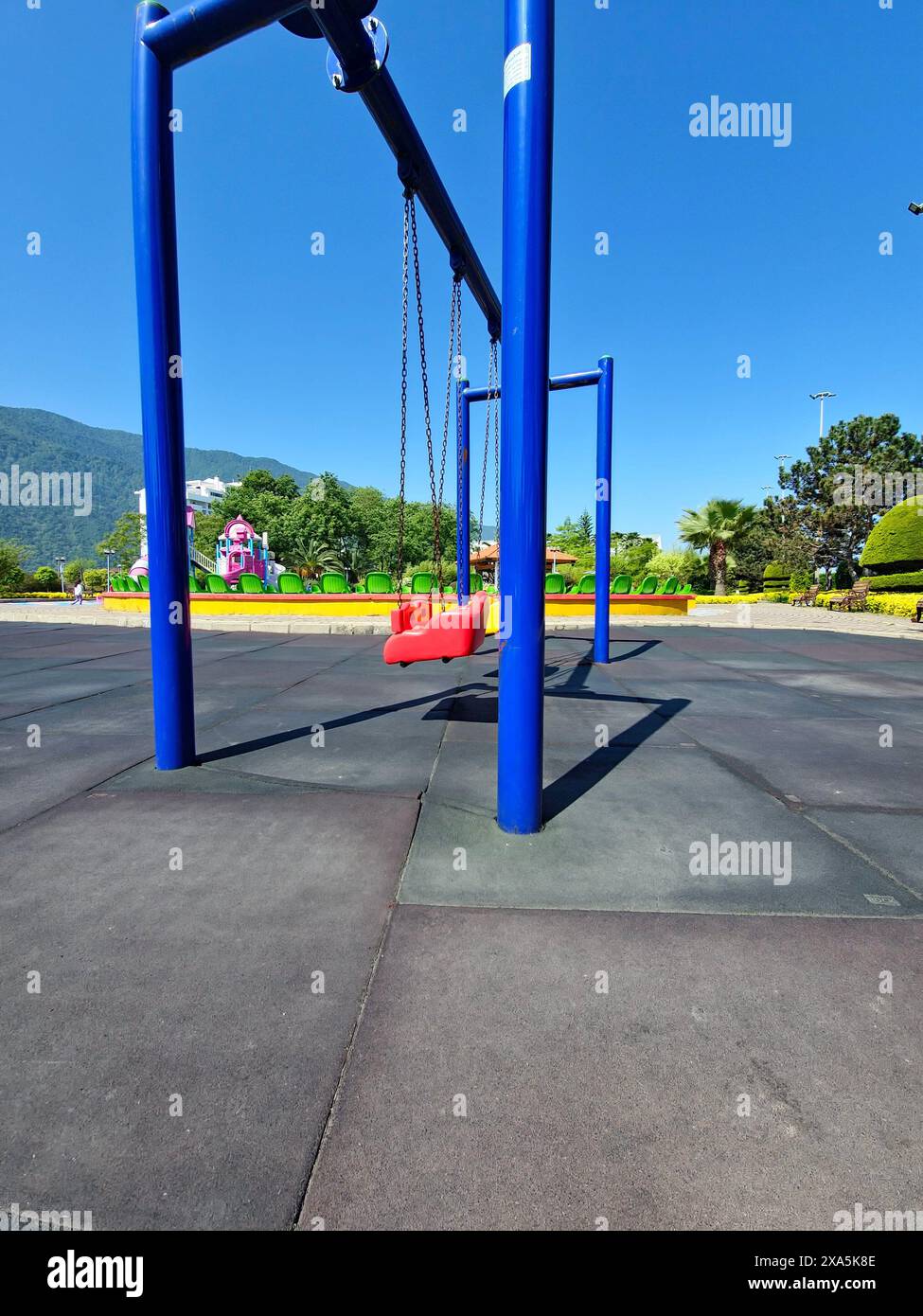 An abandoned playground with swings and distant mountains Stock Photo ...
