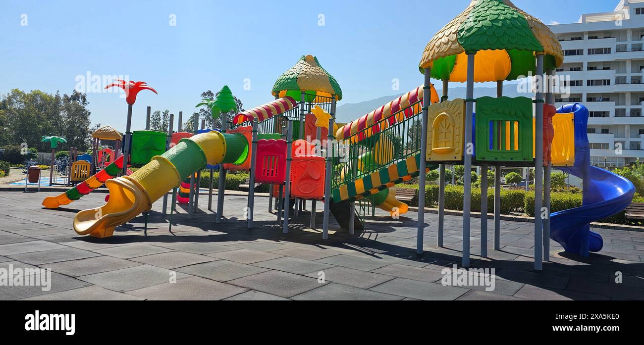 A colorful playground with tipped slides Stock Photo - Alamy