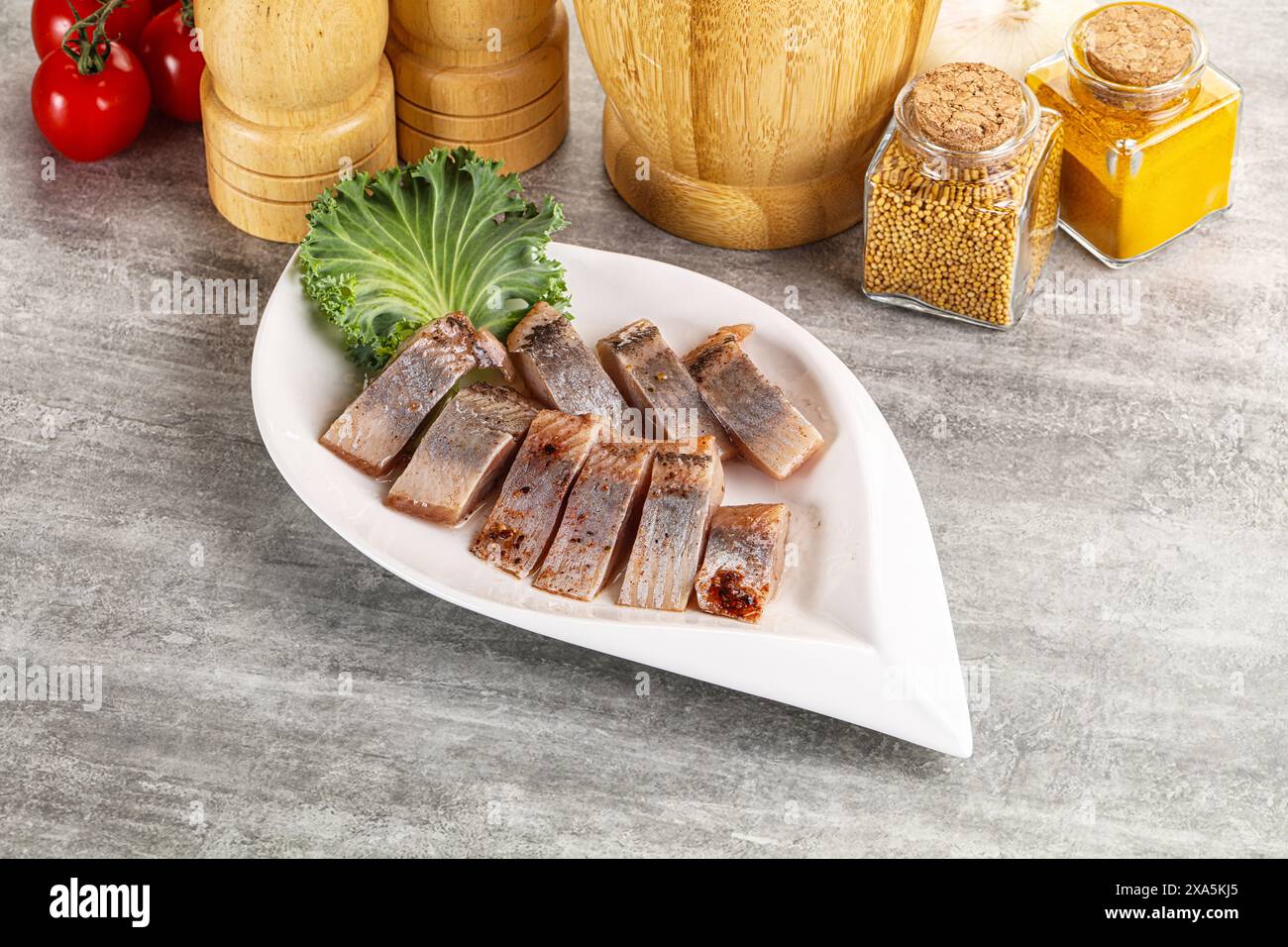 Sliced spicy salted herring fillet snack Stock Photo - Alamy