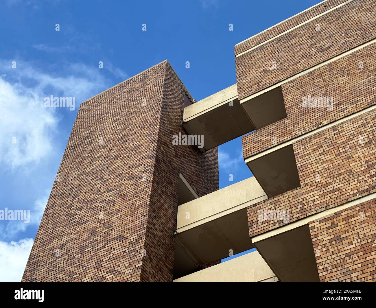 A multi-tiered brown building with diverse shapes and levels Stock ...